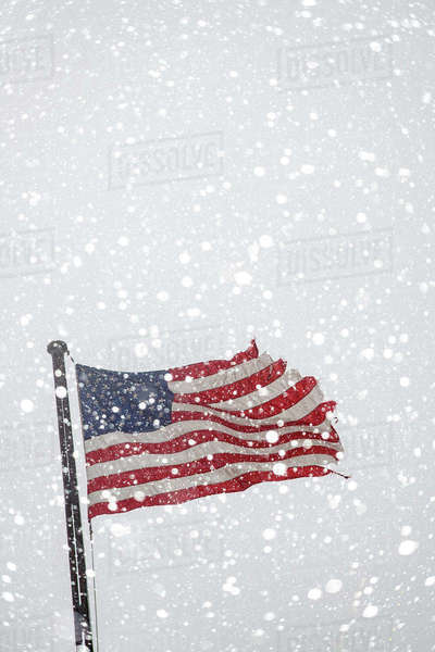 Torn American flag on flag pole with falling snow - Royalty-free Stock ...