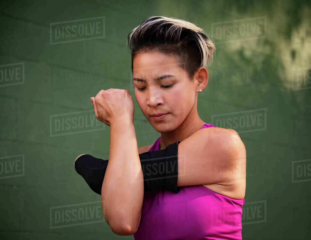 Athletic woman with amputated hand stretching arm - Royalty-free Stock ...