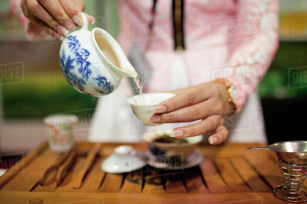 Woman pouring tea - Royalty-free Stock Photo | Dissolve