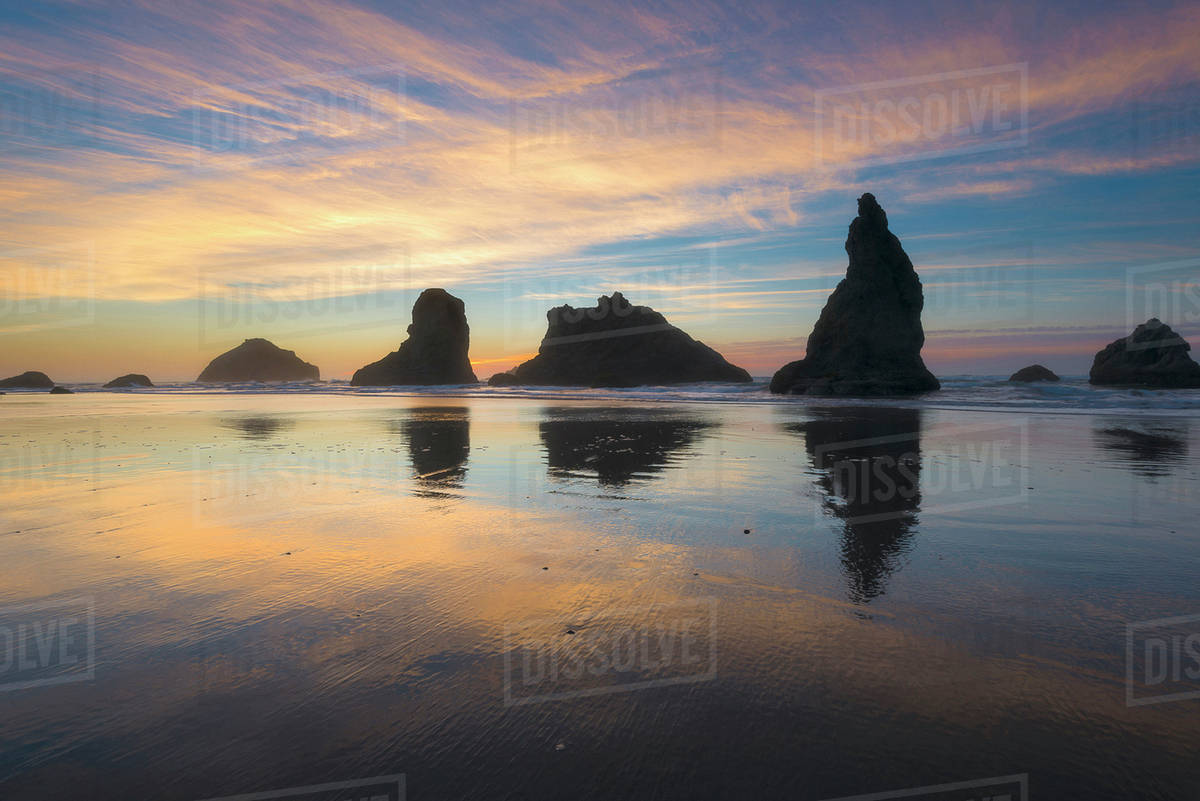 Beach with stack rocks at sunset - Royalty-free Stock Photo | Dissolve