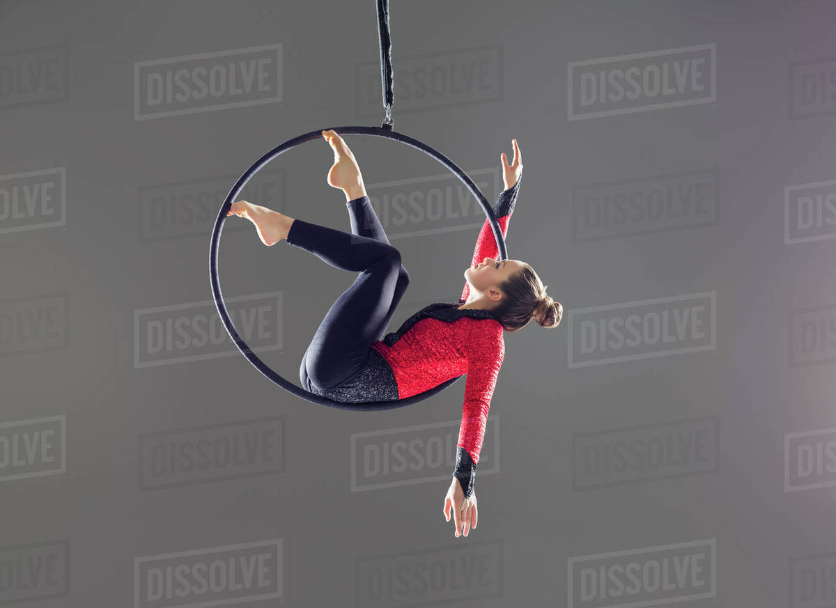 Young acrobat performing on aerial hoop - Royalty-free Stock Photo ...