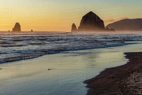 USA, Oregon, Haystack Rock at Cannon Beach at sunset - Royalty-free ...