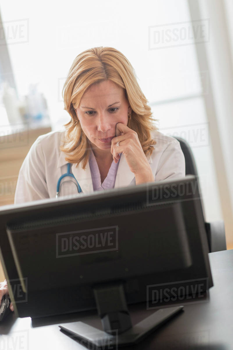 Female doctor using computer - Royalty-free Stock Photo | Dissolve