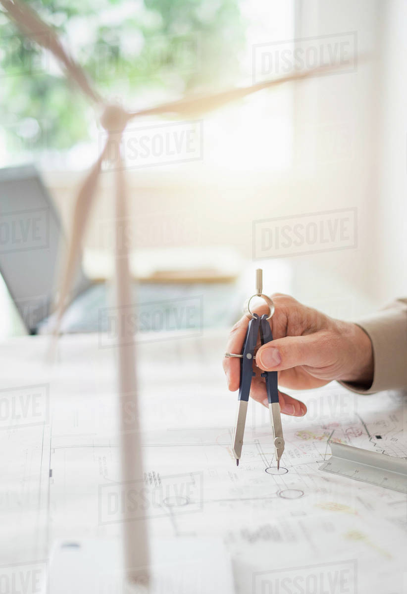 Close up of man's hands using compass while drawing plans - Royalty ...