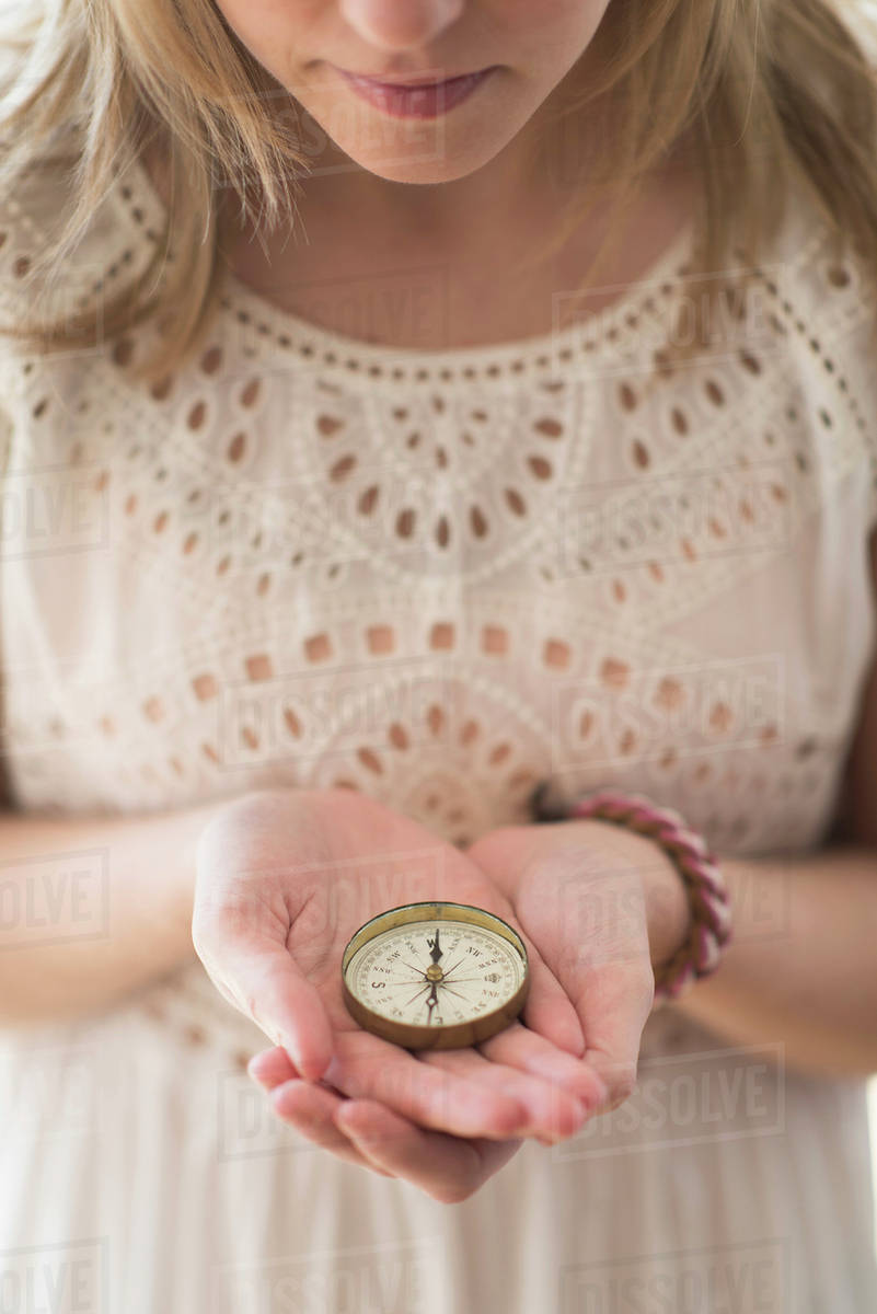 Woman holding navigation compass - Royalty-free Stock Photo | Dissolve