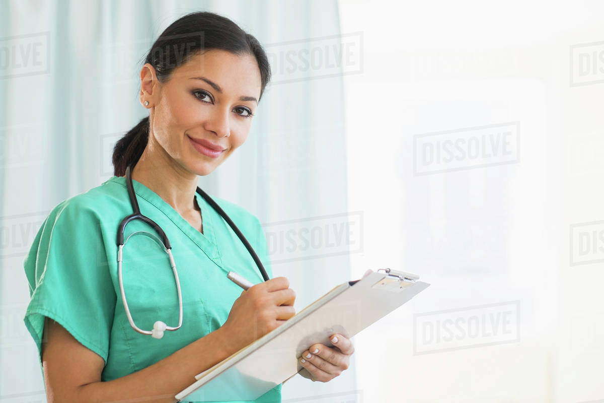 Female doctor making notes - Royalty-free Stock Photo | Dissolve