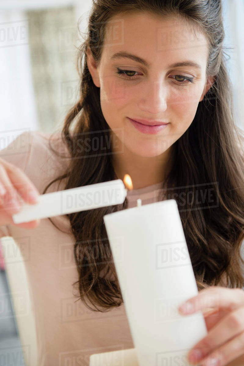 Woman lighting candle - Royalty-free Stock Photo | Dissolve