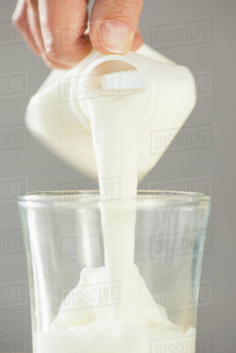 Hand pouring milk - Royalty-free Stock Photo | Dissolve