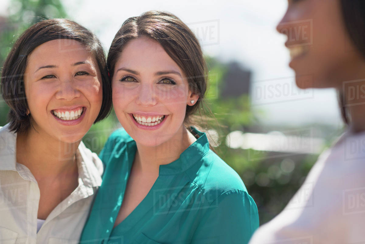 Women laughing outside - Royalty-free Stock Photo | Dissolve