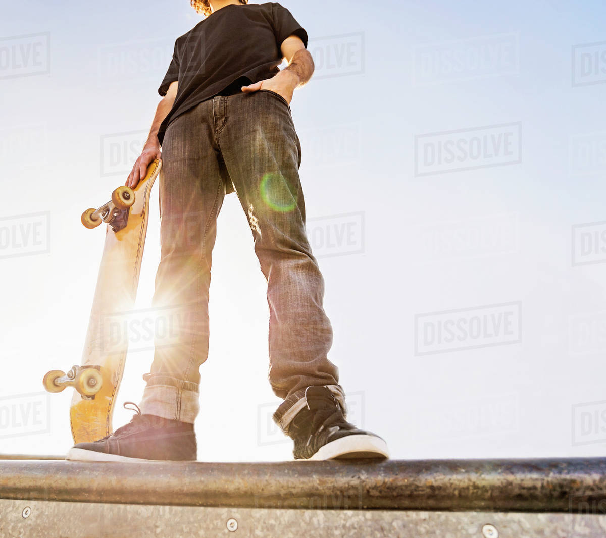 Man leaning on skateboard in skatepark - Royalty-free Stock Photo ...