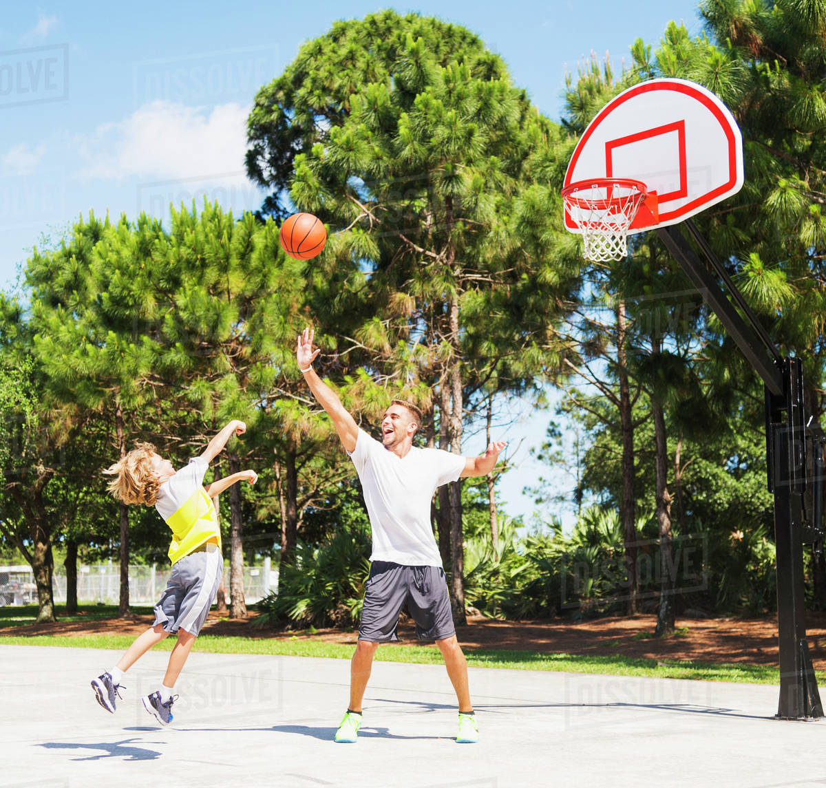 Boy (8-9) playing basketball with his brother - Royalty-free Stock ...