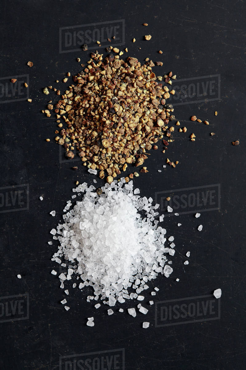 Salt and pepper on black background - Stock Photo - Dissolve