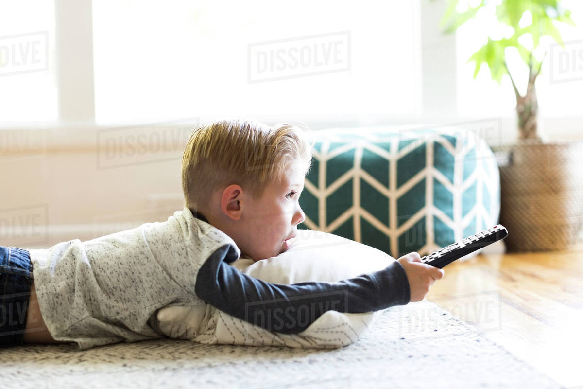 Boy (4-5) watching tv in living room - Royalty-free Stock Photo | Dissolve