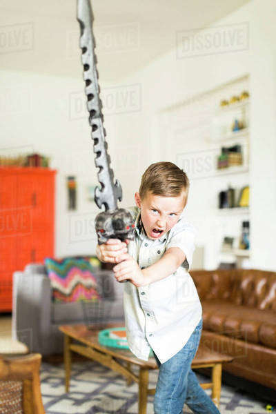 Boy (6-7) playing with sword - Royalty-free Stock Photo | Dissolve