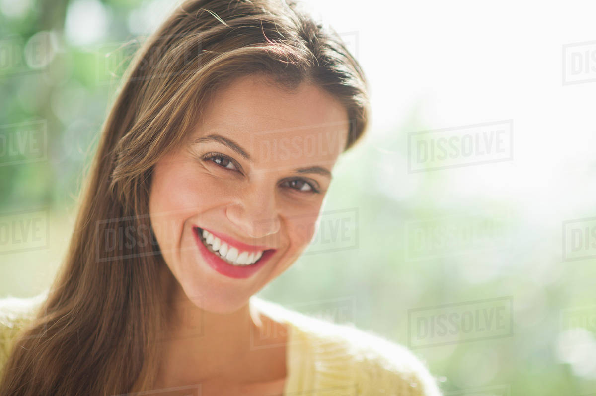 Woman smiling outdoors - Stock Photo - Dissolve