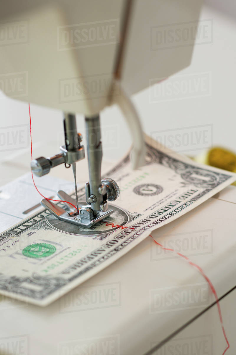 Halves of dollar bill being sewed with sewing machine - Stock Photo ...