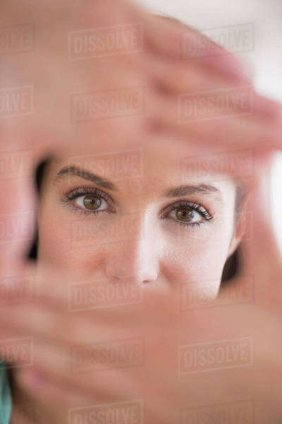 Woman looking at camera through handsframe - Royalty-free Stock Photo ...
