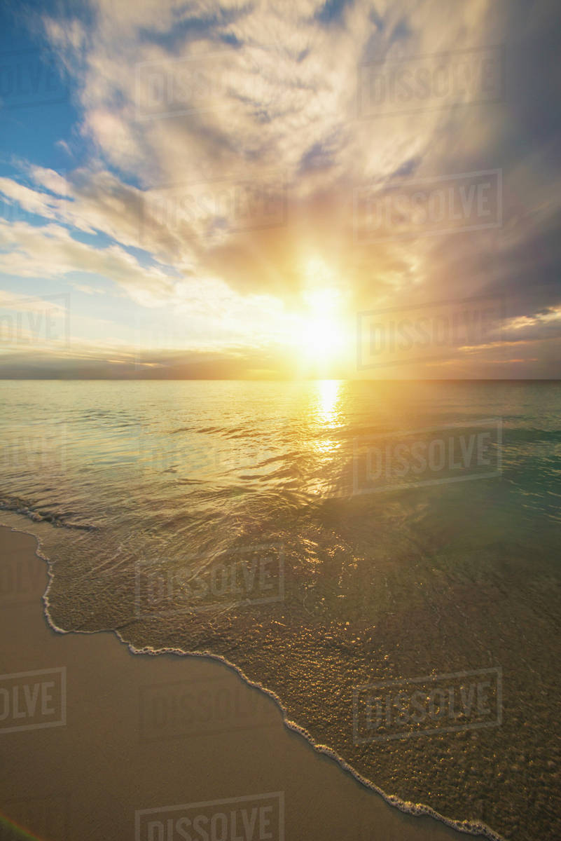 Sun setting over sea - Royalty-free Stock Photo | Dissolve