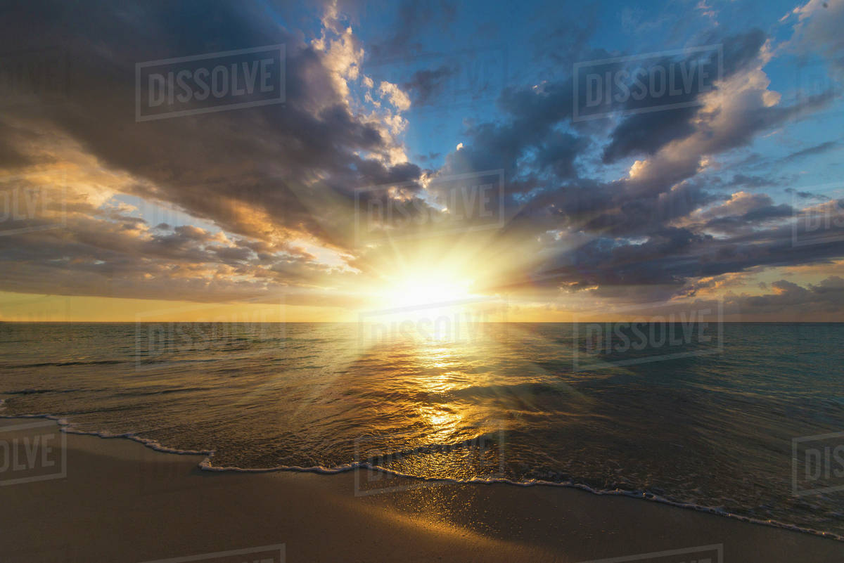 Sun setting over sea - Royalty-free Stock Photo | Dissolve