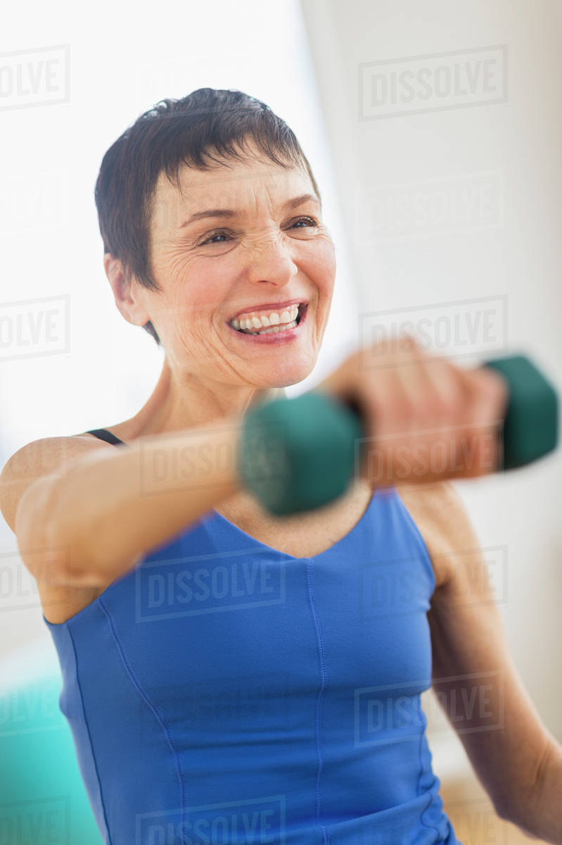 Mature woman exercising in gym - Royalty-free Stock Photo | Dissolve