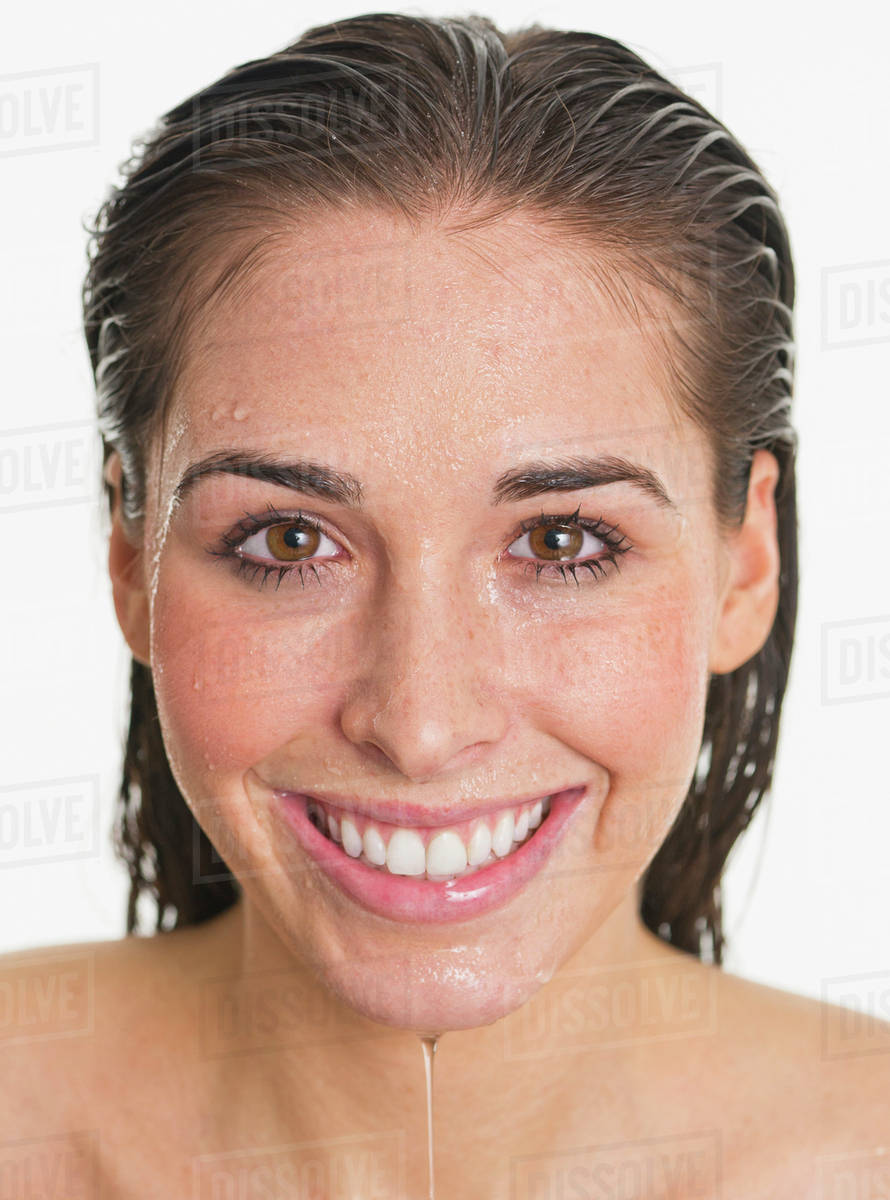 Studio portrait of woman with wet face - Stock Photo - Dissolve