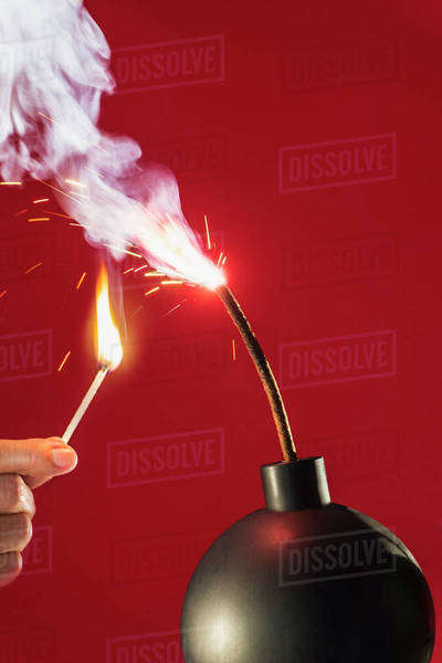 Old-fashioned explosive device ready to go off with hand holding ...