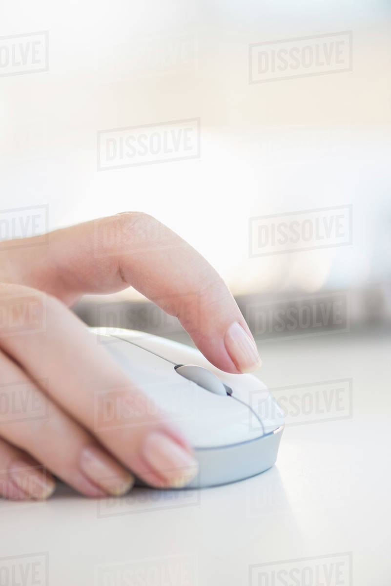 Close up of woman's hands using computer mouse - Stock Photo - Dissolve