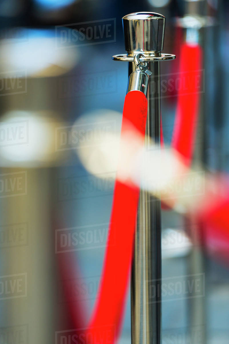 Red rope and stanchions - Stock Photo - Dissolve
