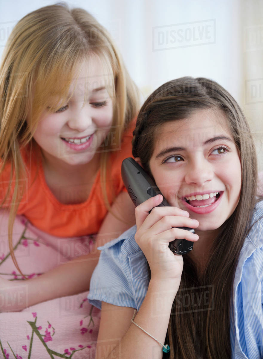 Close up of two girls talking on phone - Royalty-free Stock Photo ...