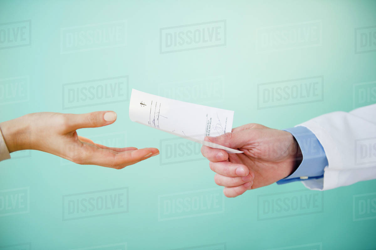 Close up of doctor's hand giving prescription to patient, studio shot ...