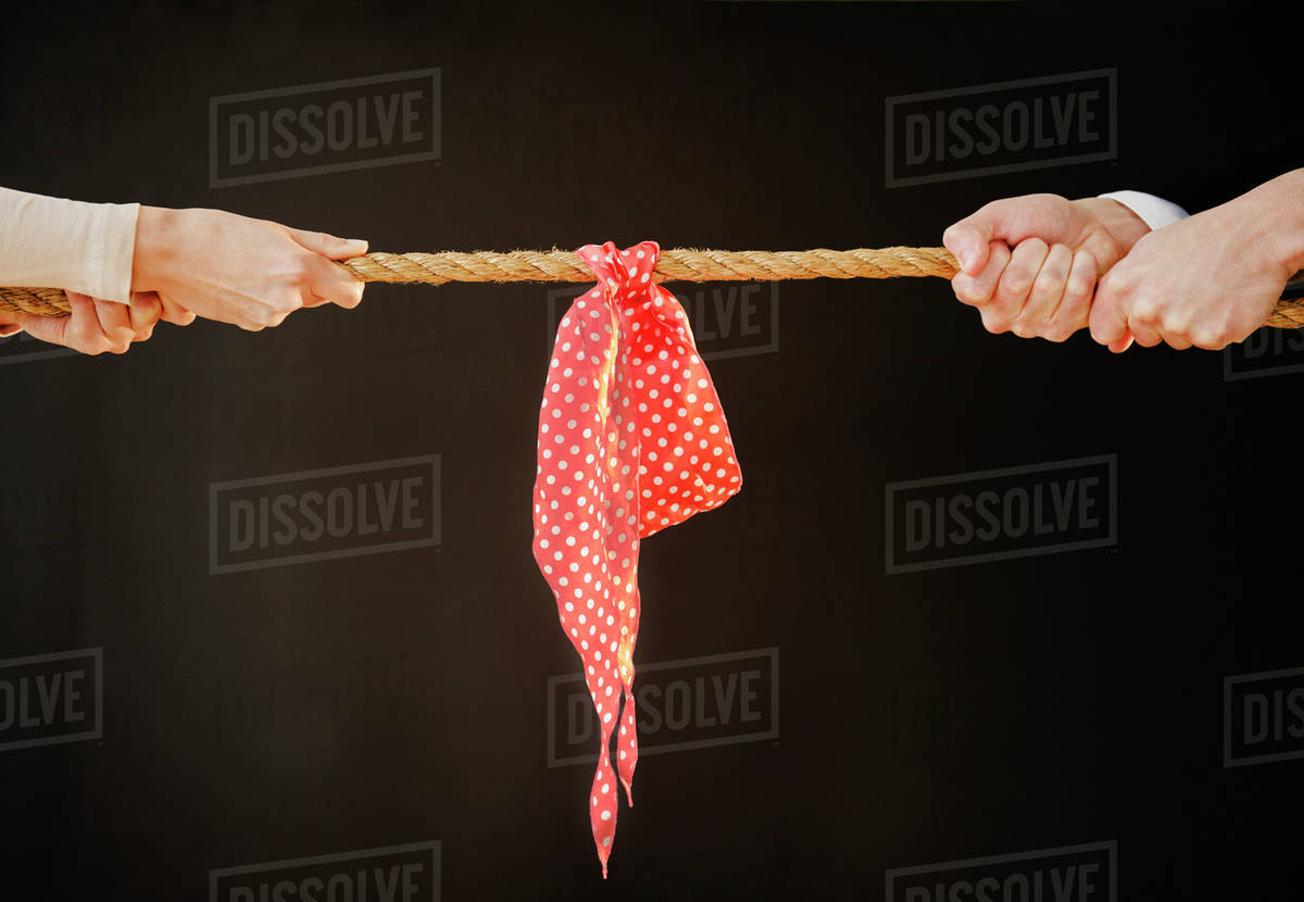 Close up of man's and woman's hands pulling rope, studio shot - Stock ...