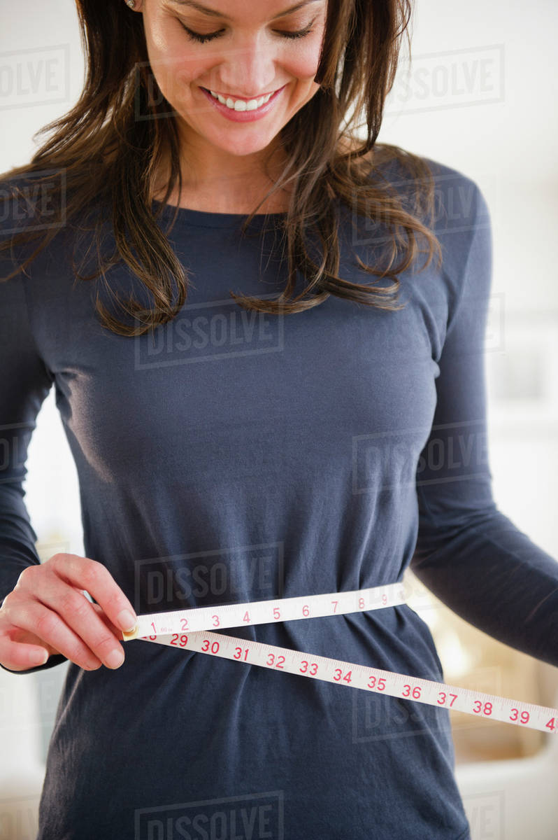 Woman measuring herself with measuring tape - Royalty-free Stock Photo ...