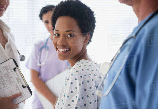 Female patient among hospital staff - Royalty-free Stock Photo | Dissolve