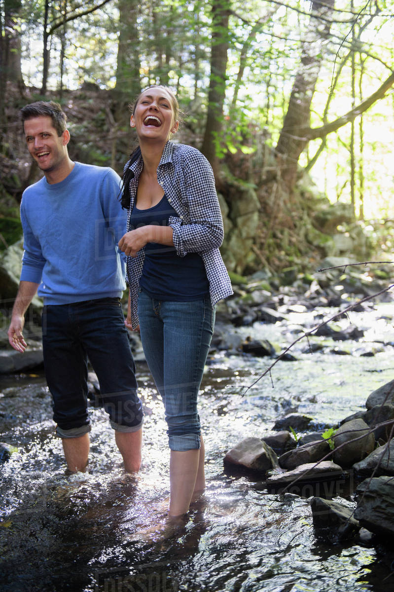 Couple wading in stream - Royalty-free Stock Photo | Dissolve