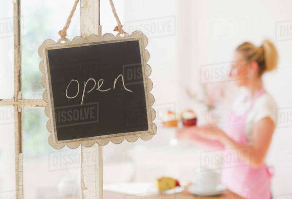 Close up of open sign with woman in background - Royalty-free Stock ...