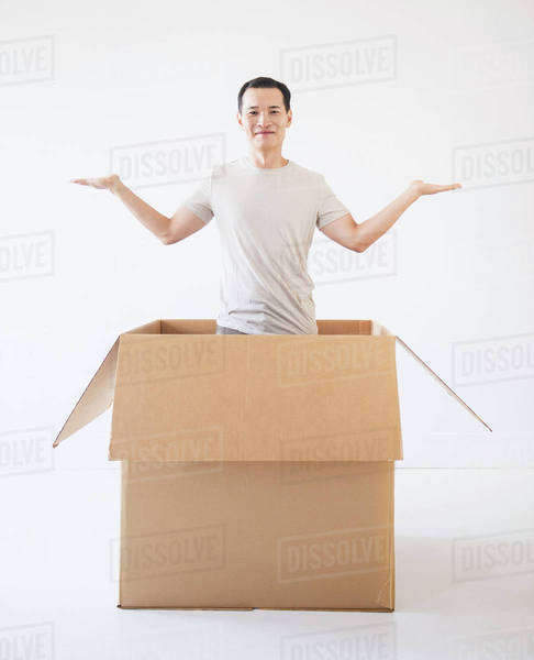 Man popping out from cardboard box - Royalty-free Stock Photo | Dissolve