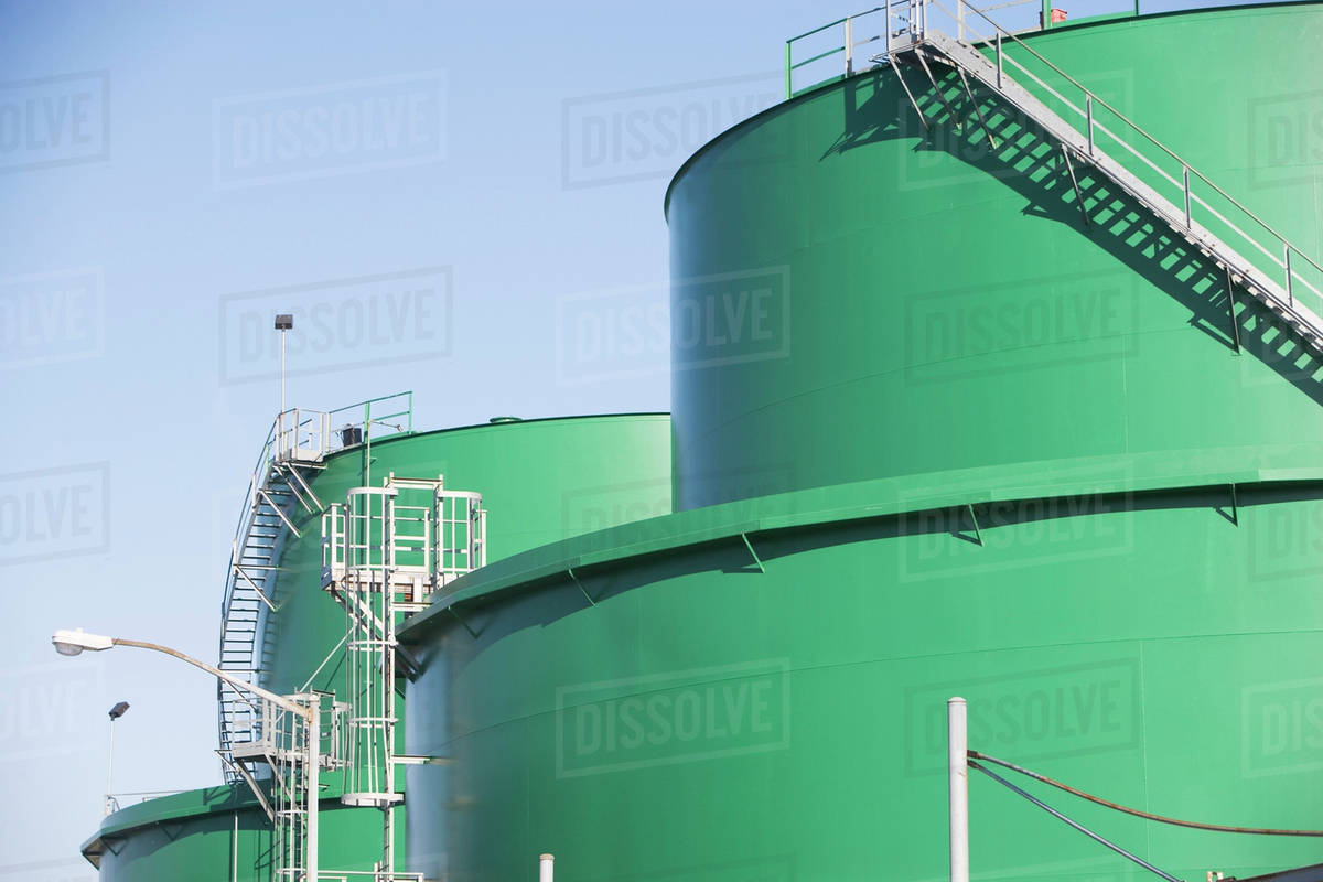 USA, New York City, Green storage tanks - Stock Photo - Dissolve