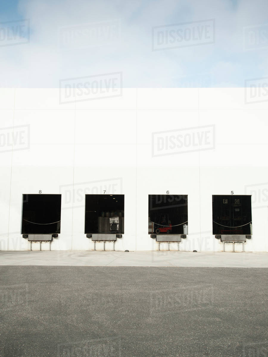 Warehouse with open loading docks - Royalty-free Stock Photo | Dissolve