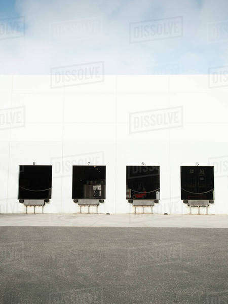 Warehouse with open loading docks - Royalty-free Stock Photo | Dissolve