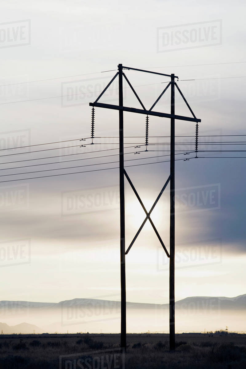 Power lines and tower at sunset - Royalty-free Stock Photo | Dissolve
