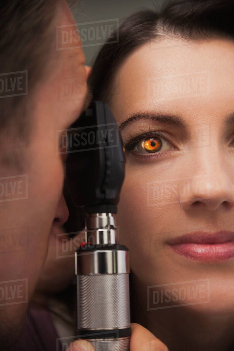 Close up of woman's eye lit up from doctor doing eye test - Stock Photo ...
