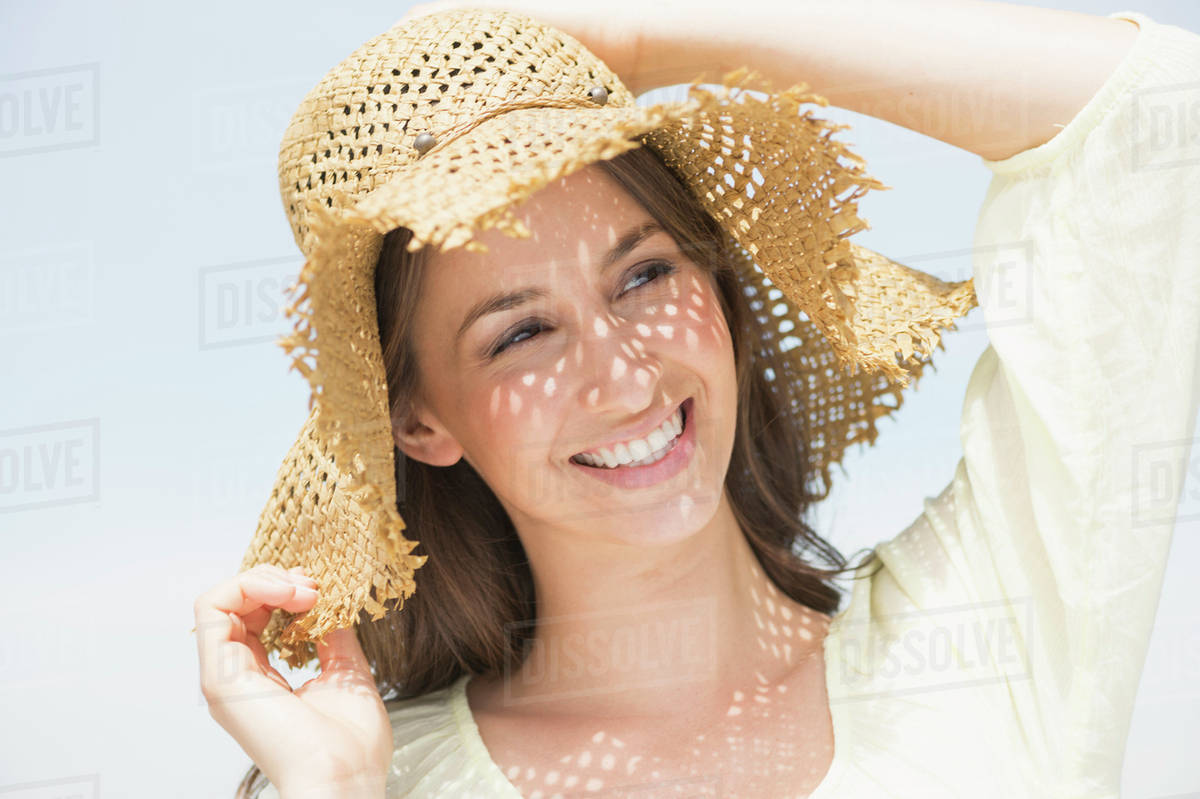 Portrait of beautiful young woman in sun hut - Stock Photo - Dissolve