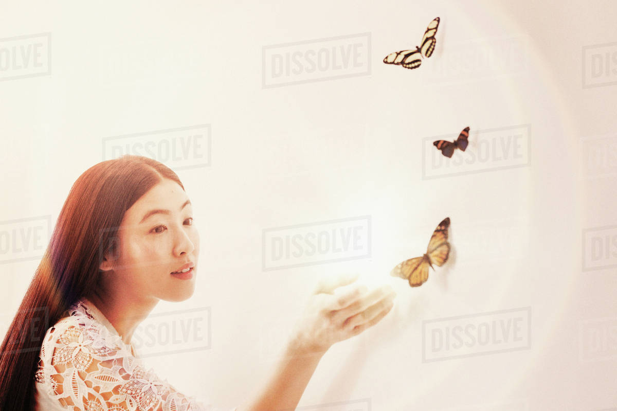 Studio shot of woman looking at butterflies - Royalty-free Stock Photo ...