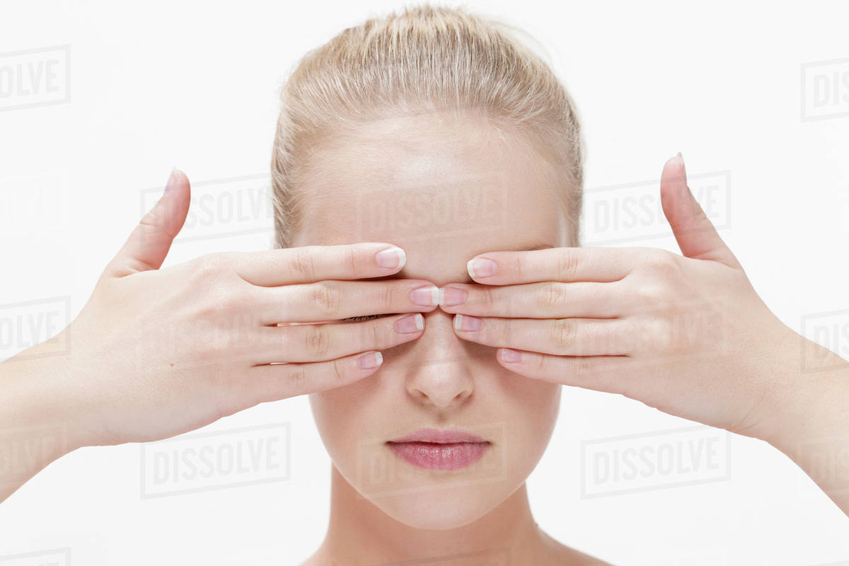 Beauty portrait of woman covering eyes - Stock Photo - Dissolve