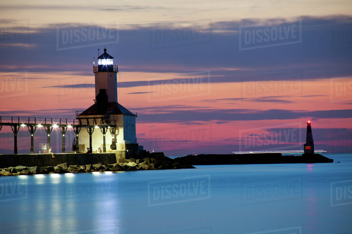 Michigan City Lighthouse at sunset. Chicago skyscrapers seen far in ...