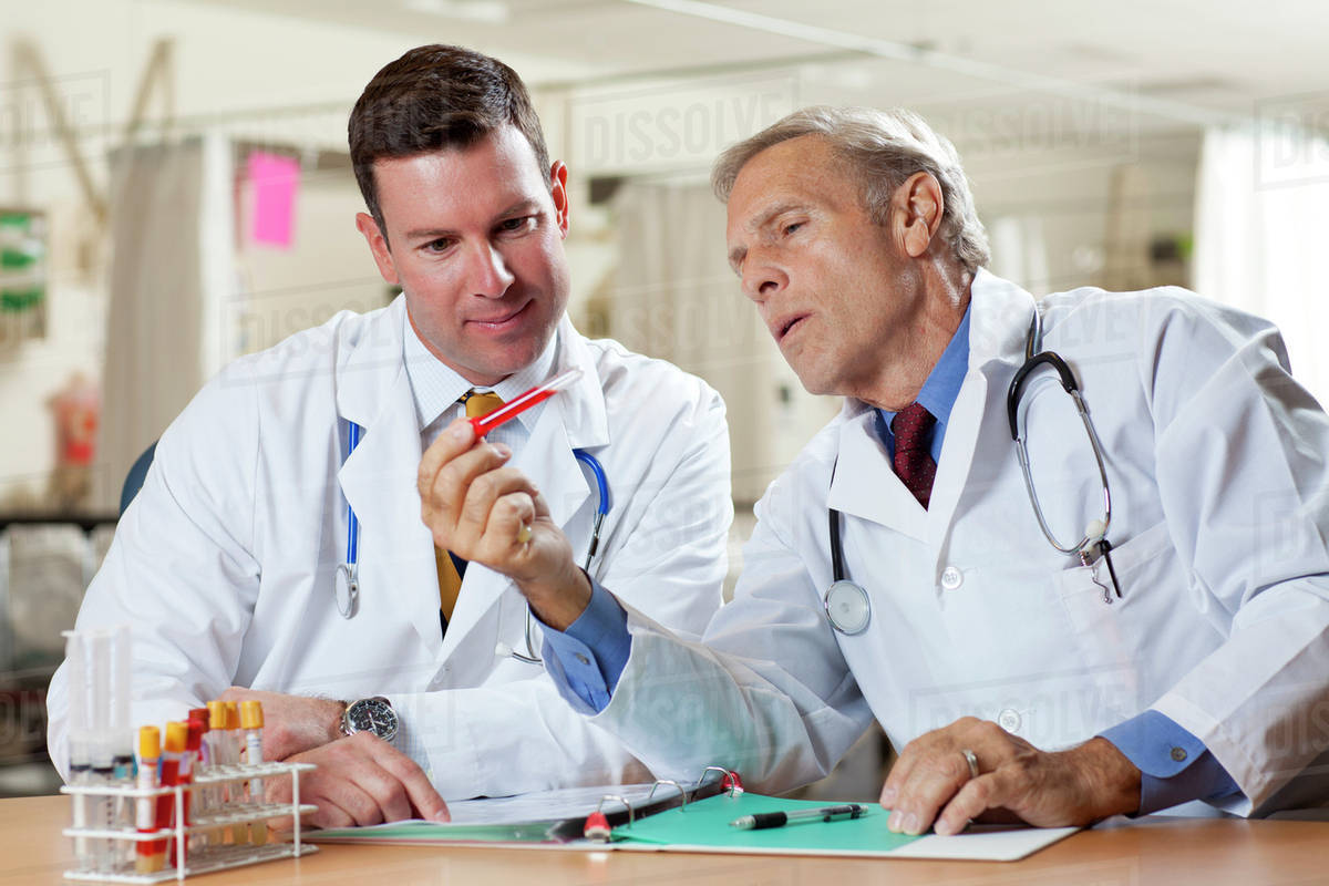 Two doctors examining test tube in hospital - Royalty-free Stock Photo ...