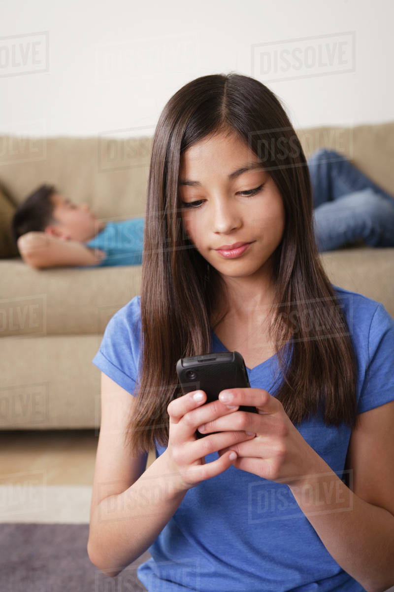 Girl using smartphone - Royalty-free Stock Photo | Dissolve