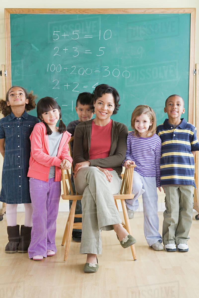 Teacher and children (6-7) posing in classroom - Royalty-free Stock ...