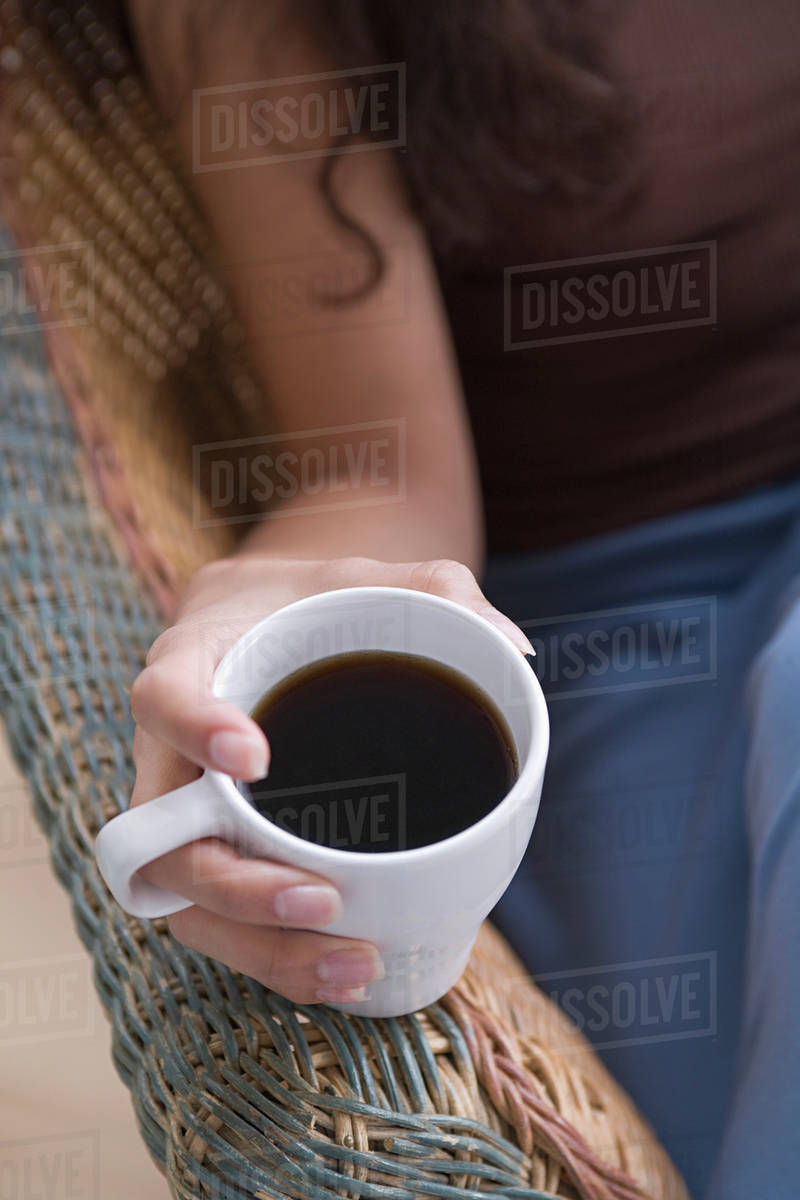 Hand holding cup of coffee - Royalty-free Stock Photo | Dissolve