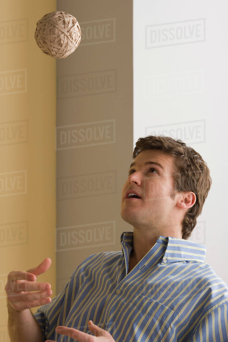 Young man playing with ball made of paper - Royalty-free Stock Photo ...